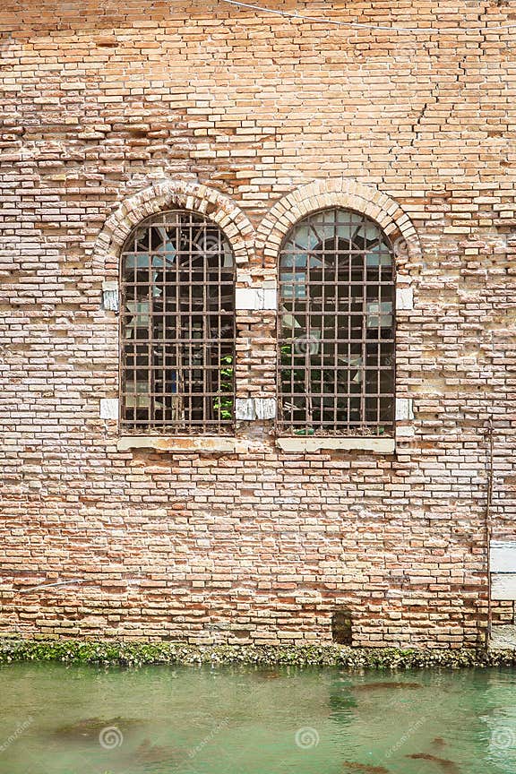 Stone wall with windows stock image. Image of design - 74297849