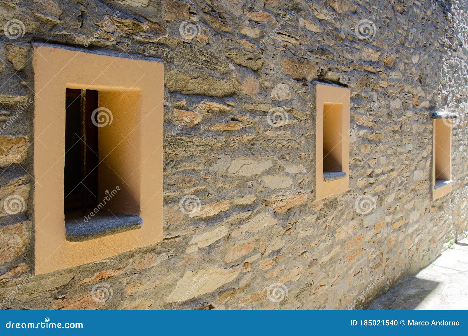 Stone wall with windows stock photo. Image of shade - 185021540