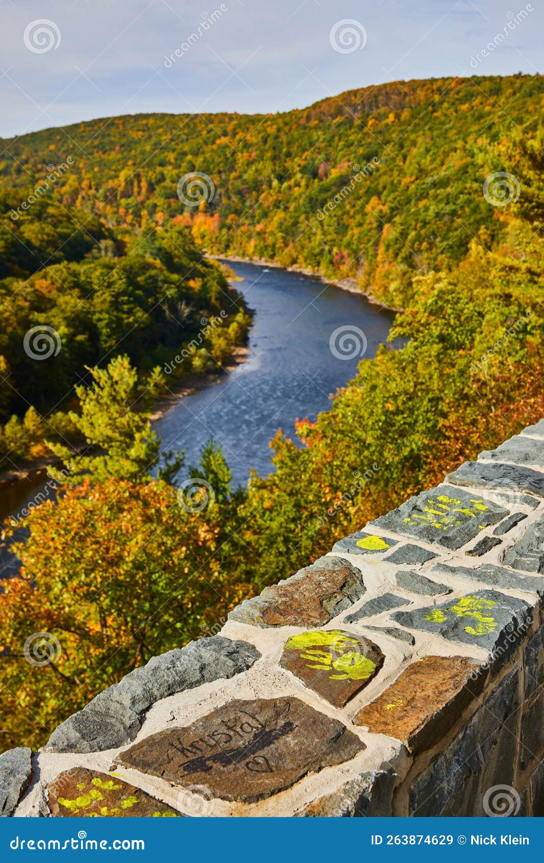 Stone Wall with Yellow Graffiti with Out of Focus River and Fall Forest ...