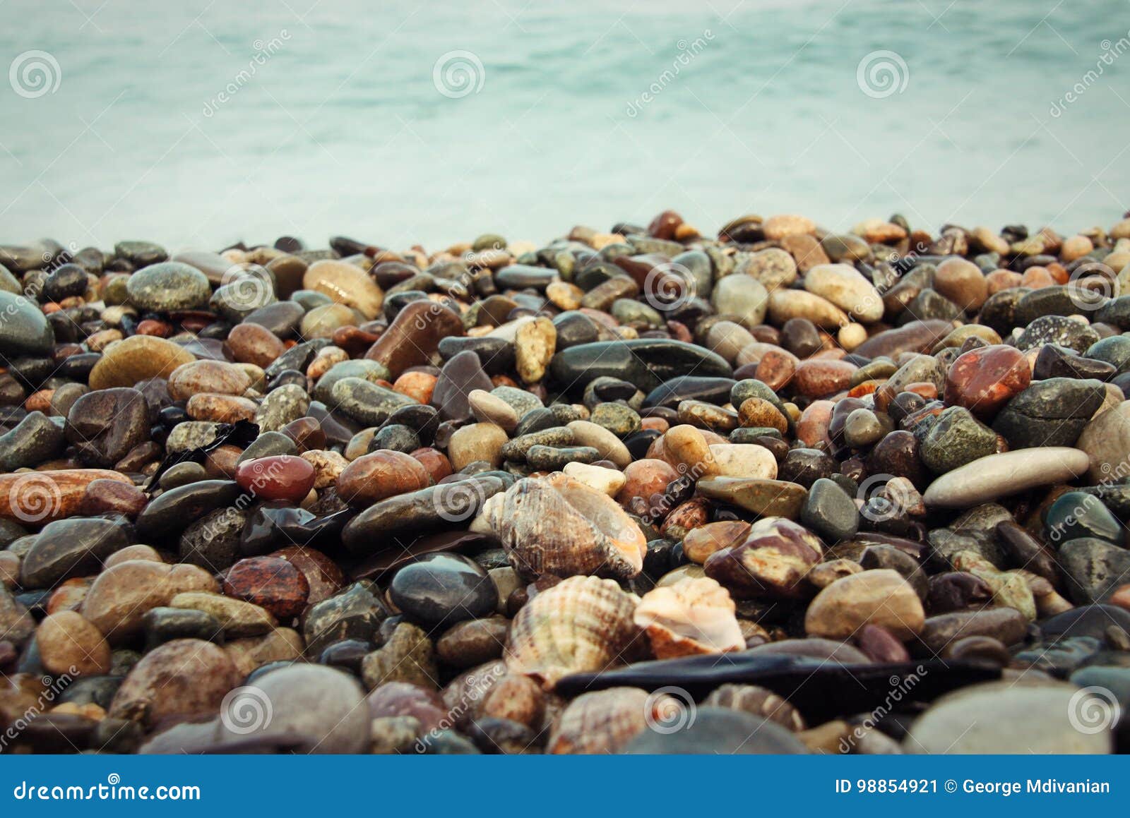 Stones background on beach stock image. Image of pebbles - 98854921