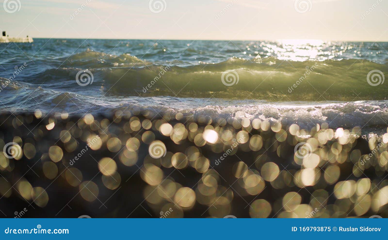 Stones on Beach and Sea Water. Wave and Shiny Pebbles on the Beach ...