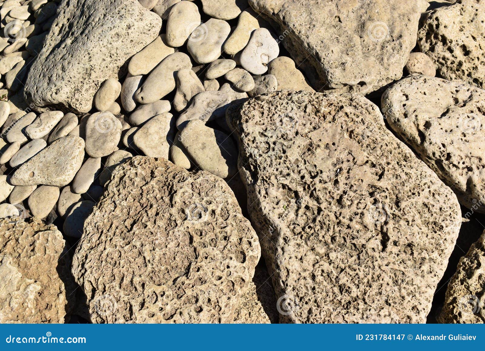 Stones of different sizes stock image. Image of asphalt - 231784147