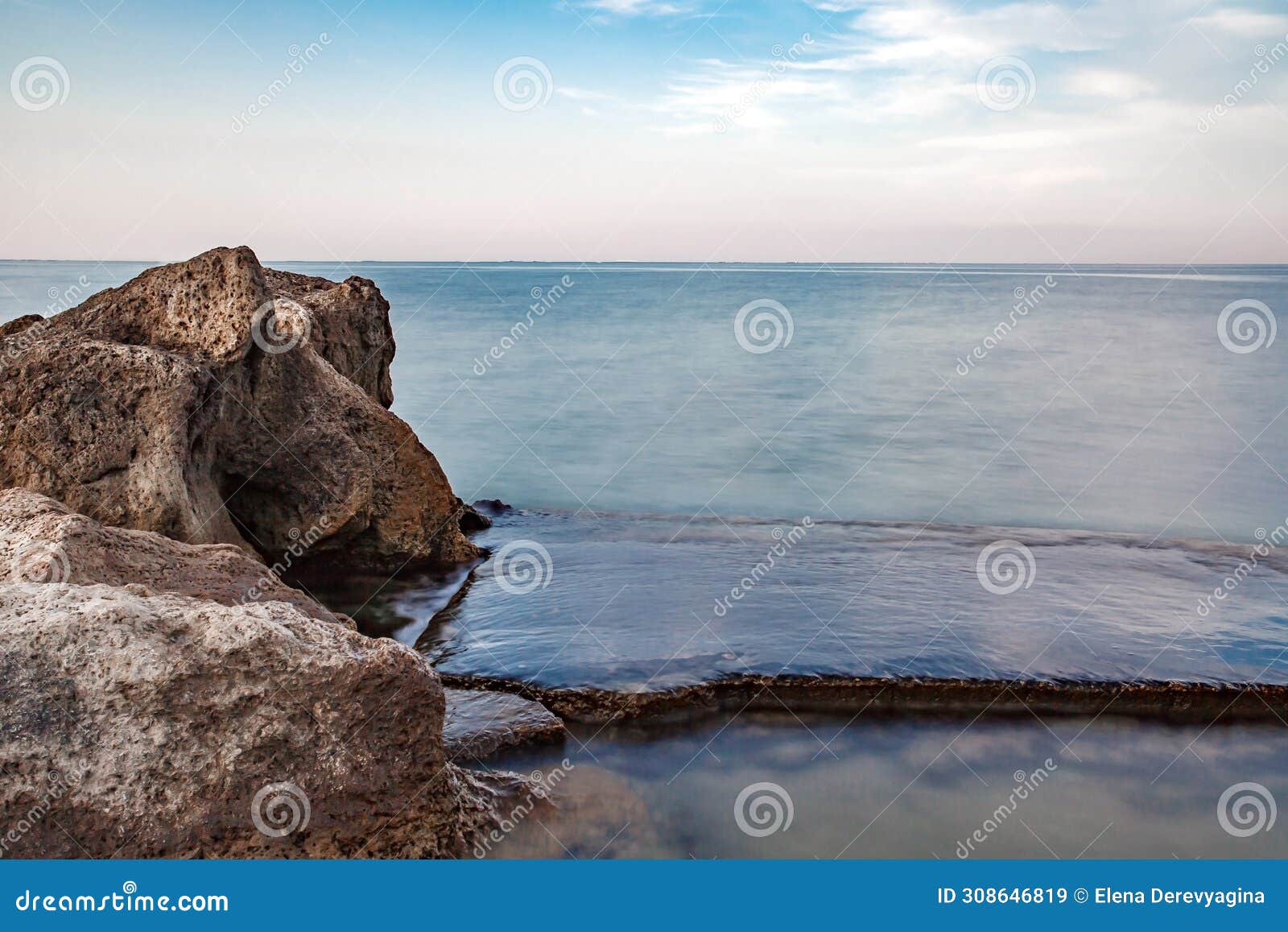 Stones Flat in Water and Rocks on Seashore, Blurred Water Movement ...