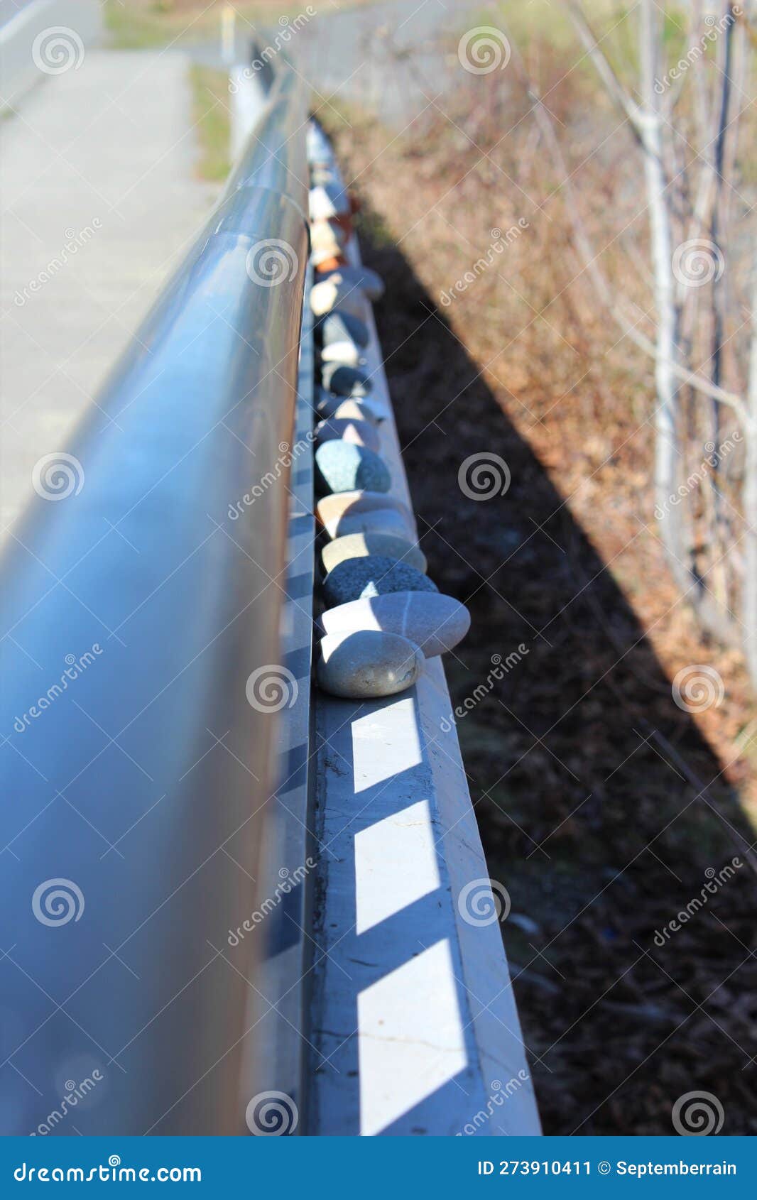 Stones lined up on a rail stock image. Image of concept - 273910411