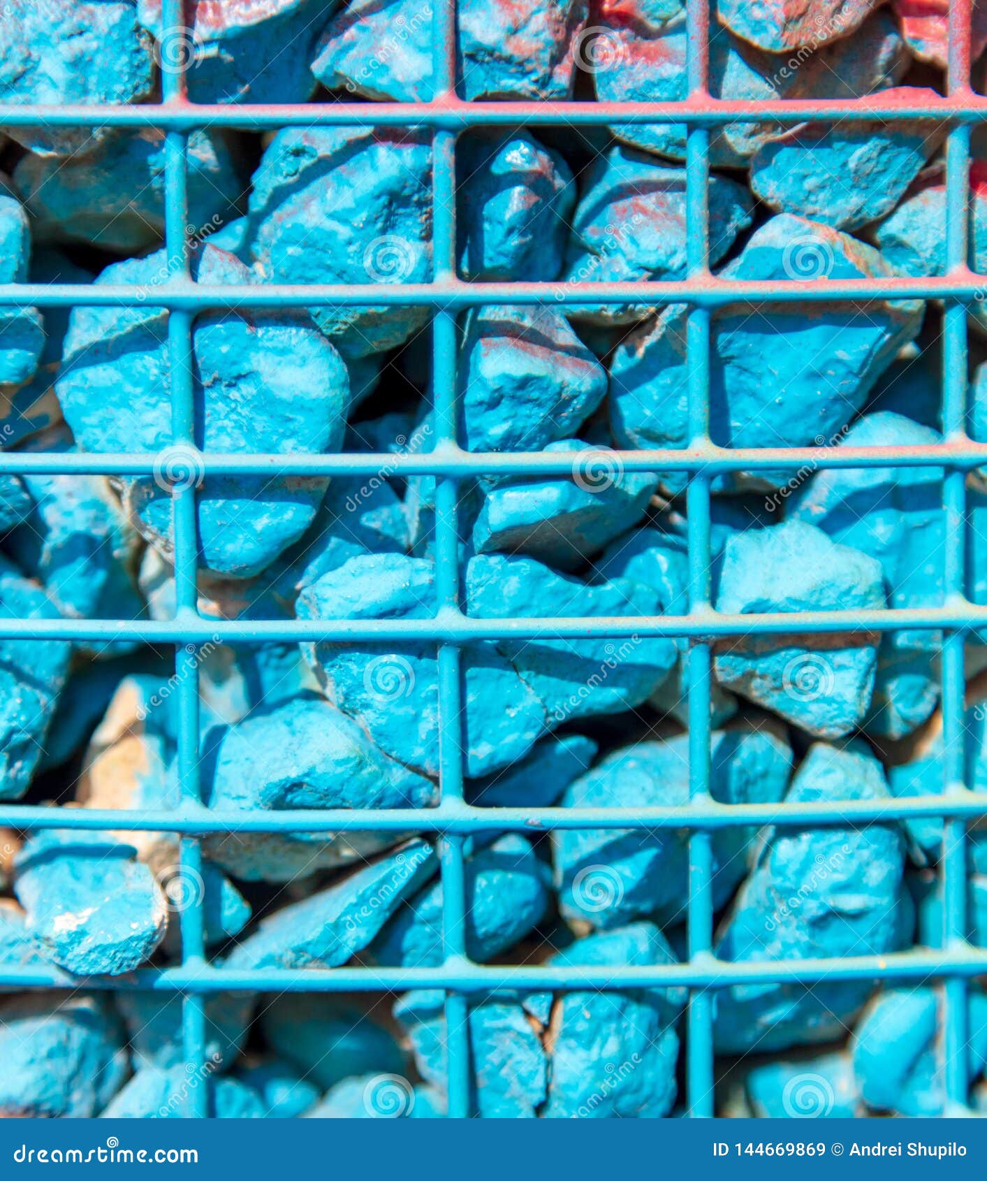 Stones Painted with Blue Paint in a Metal Grid As a Background Stock ...