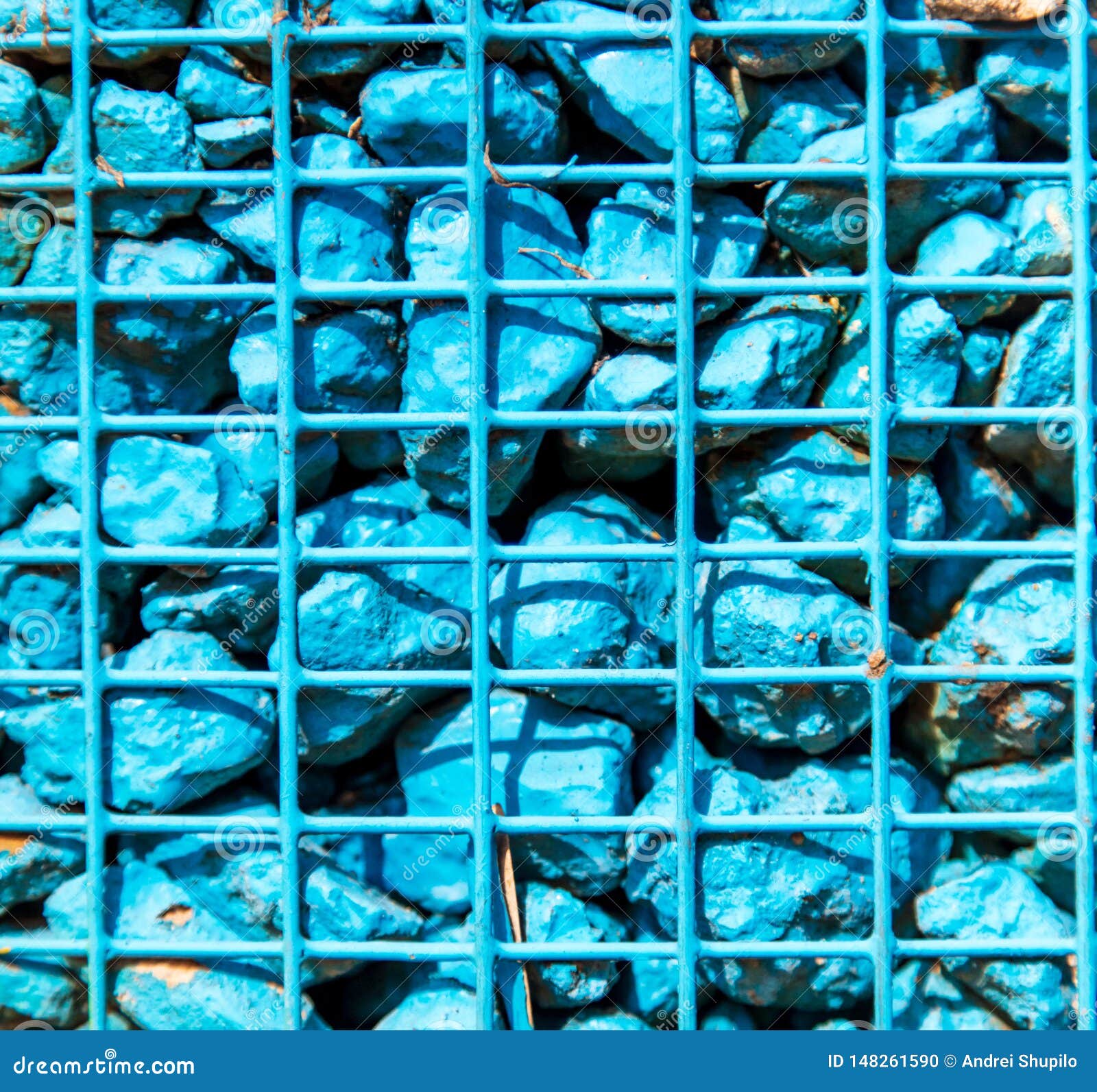 Stones Painted with Blue Paint in a Metal Grid As a Background Stock ...