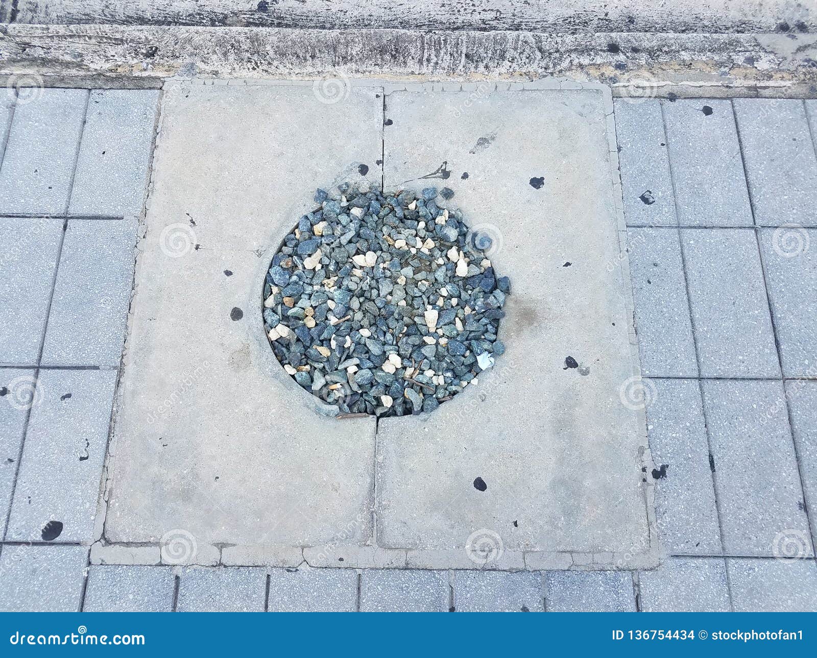 Stones or Pebbles in Hole Where Tree Was with Brick Sidewalk Stock ...