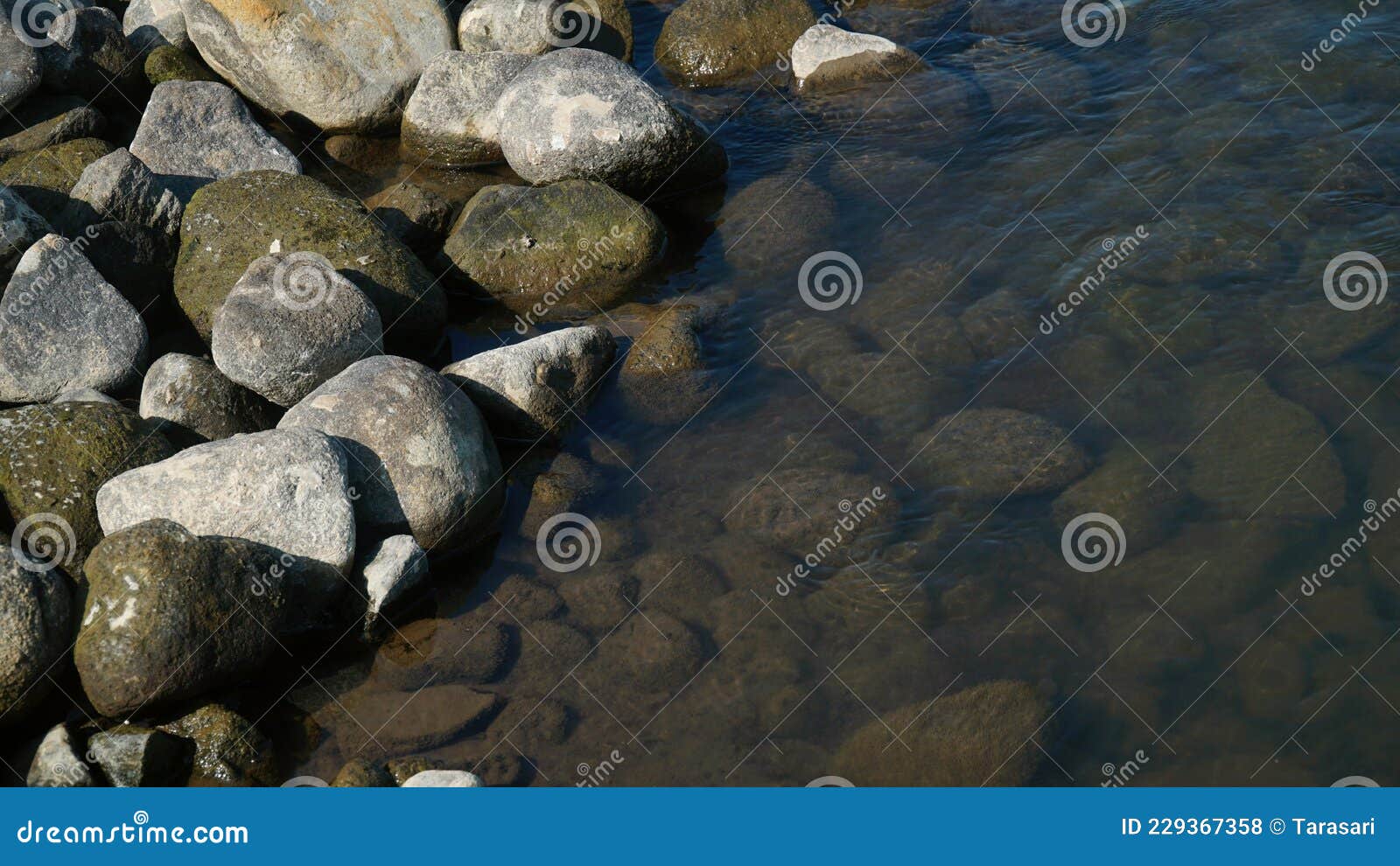 The Stones and Pebbles on the River Bank, Some are Submerged in Water ...
