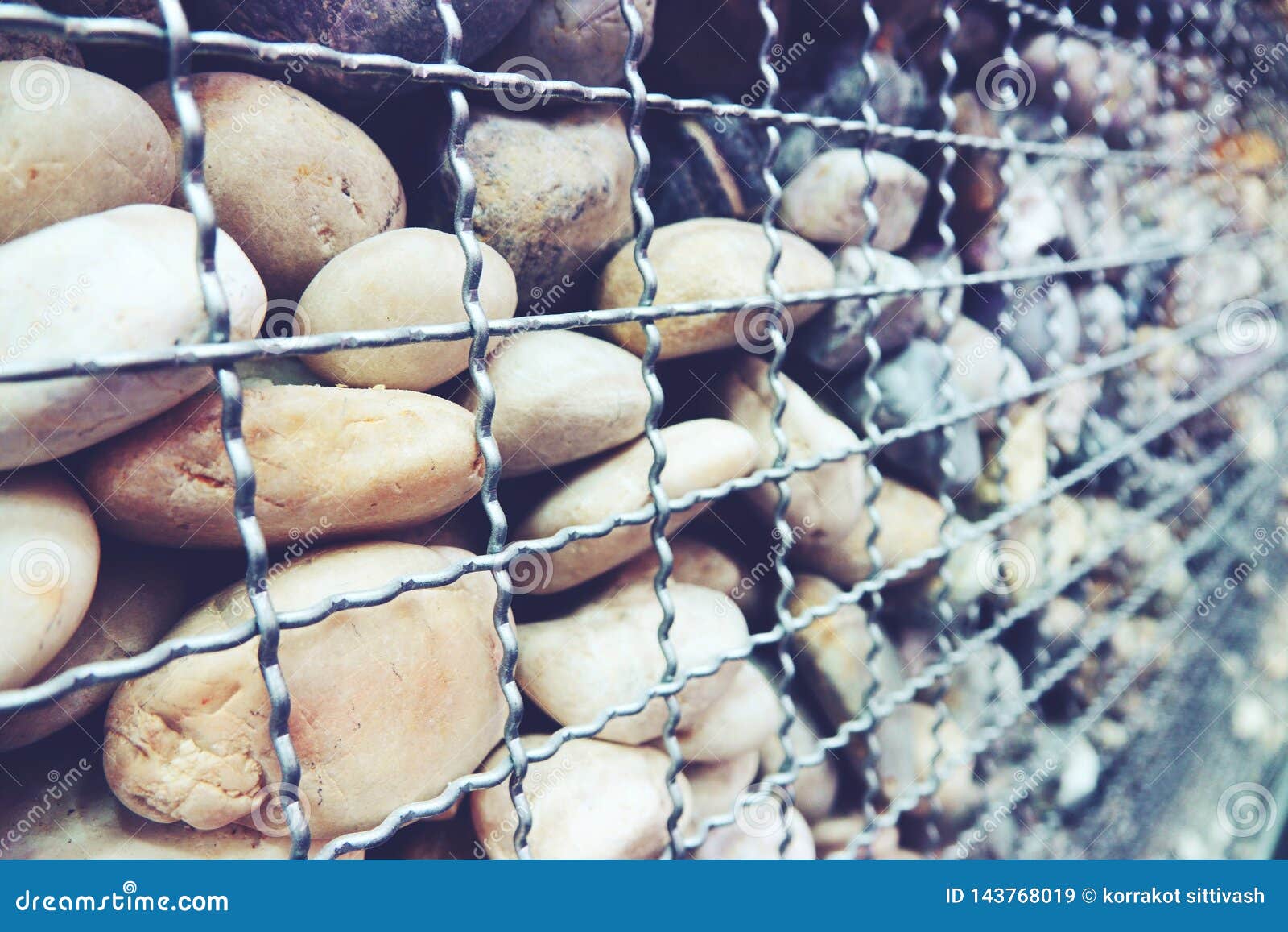 Stones and Pebbles Wall in Wire Mesh Stock Image - Image of design ...