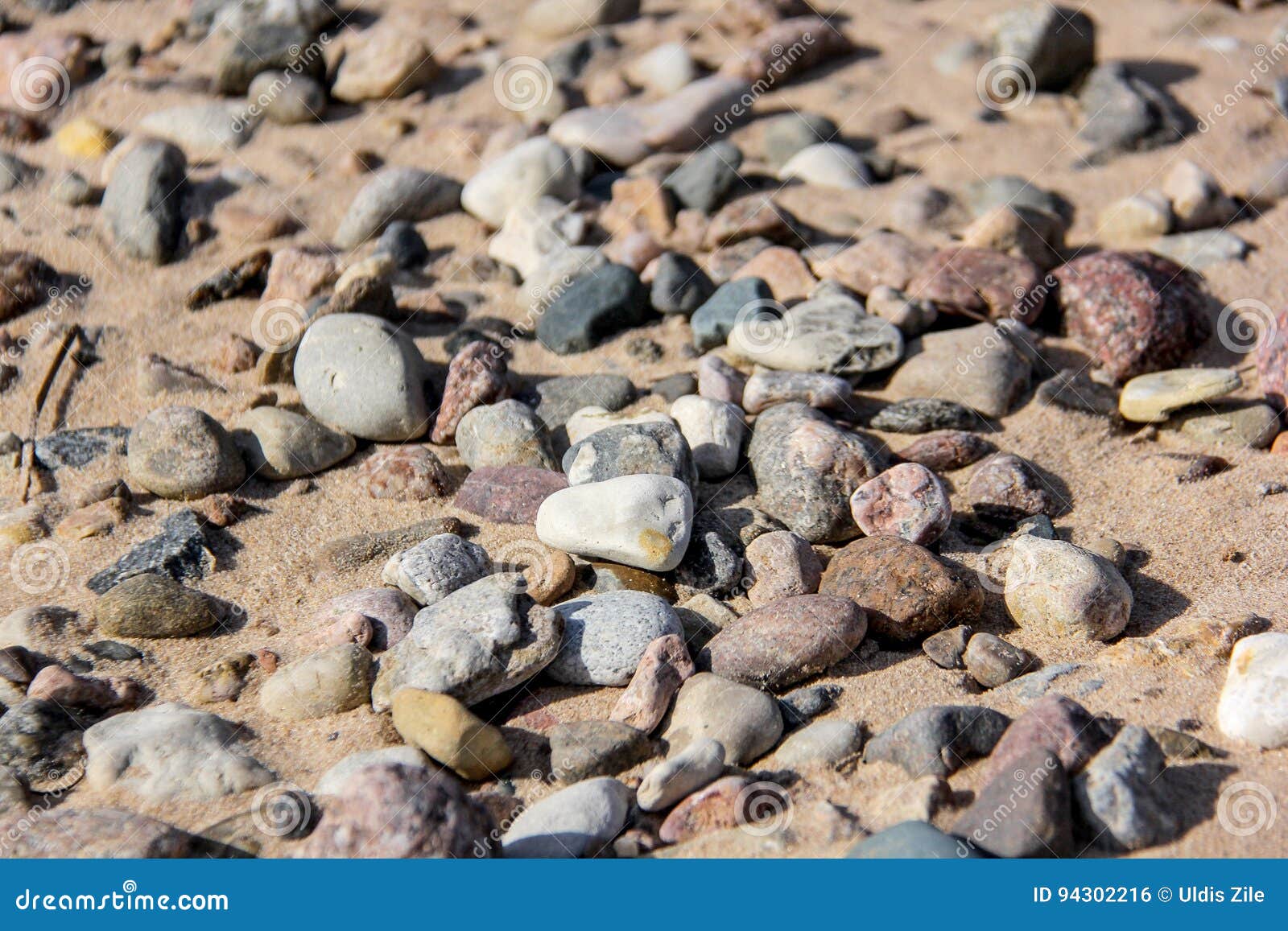 Stones on sandy beach stock photo. Image of stones, textured - 94302216