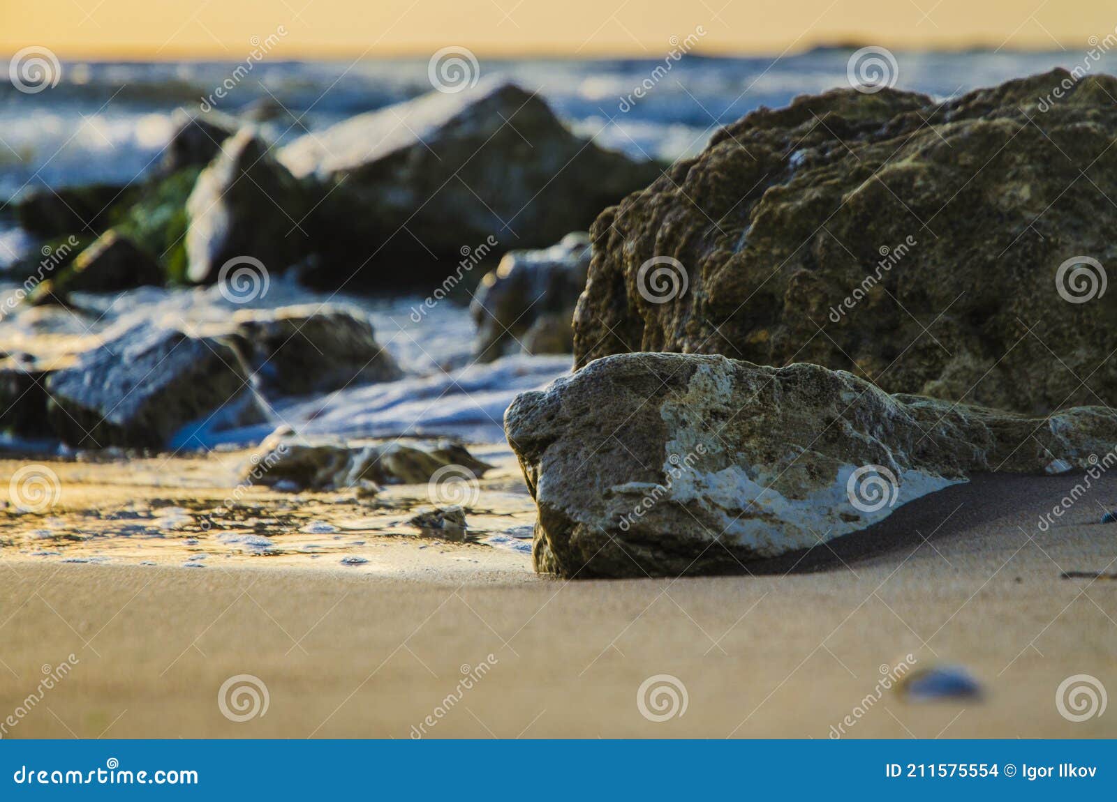 Stones on the seashore stock photo. Image of blue, island - 211575554