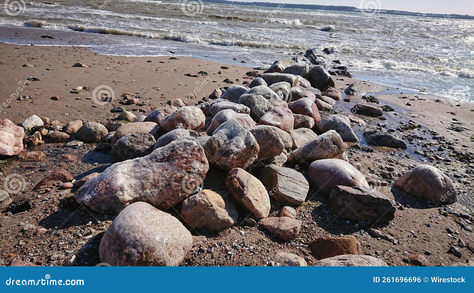 Stones by the seaside stock photo. Image of building - 261696696
