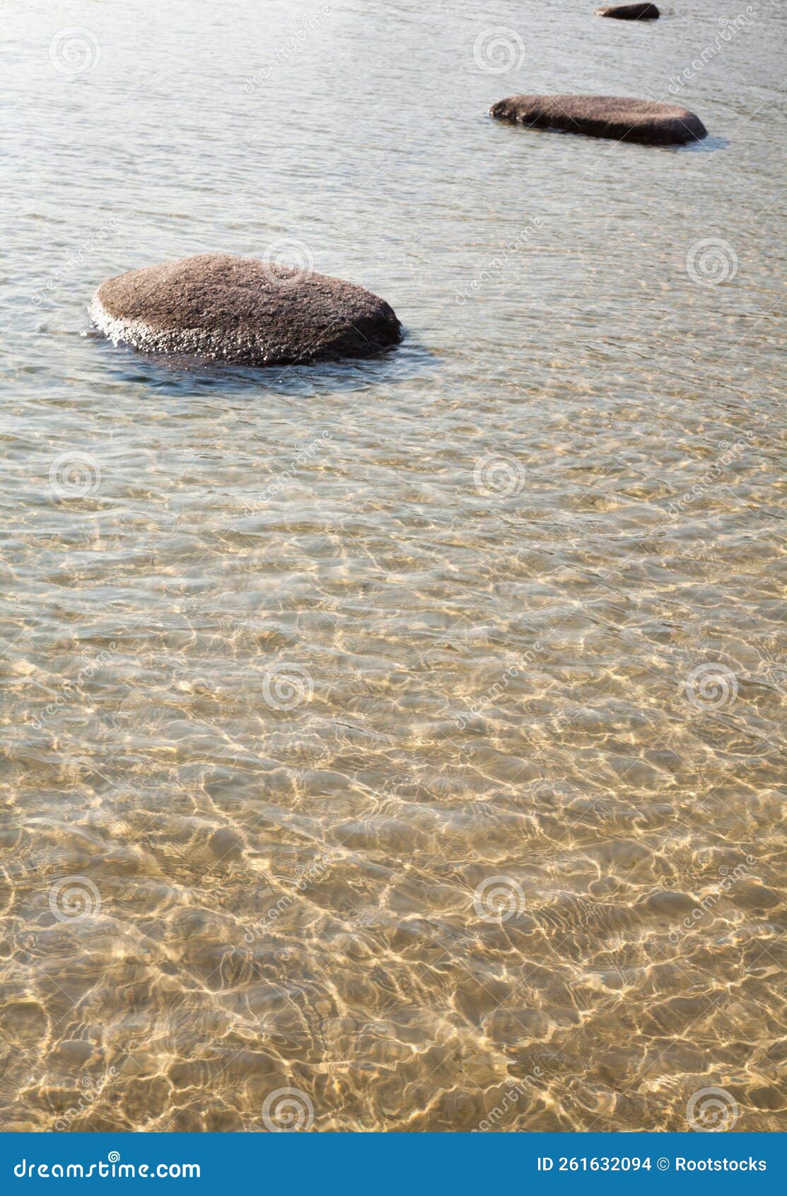 Stones in shallow water stock photo. Image of boulder - 261632094