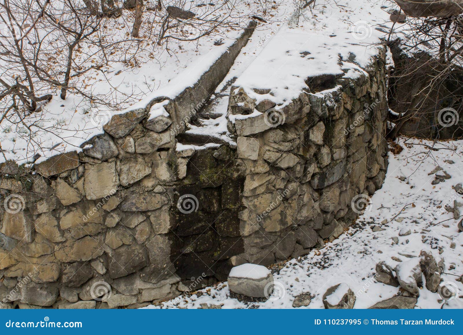 Stones in the Snow Along a Path with a Stone Wall Lining the River ...
