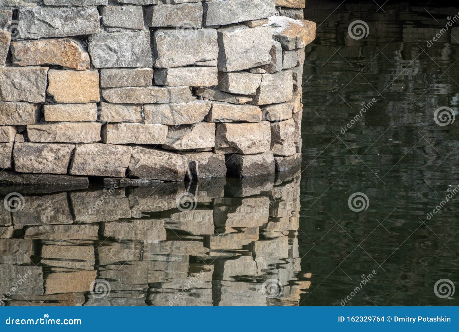 Stonework of a Bridge Pylon with Reflection in the Water Stock Photo ...