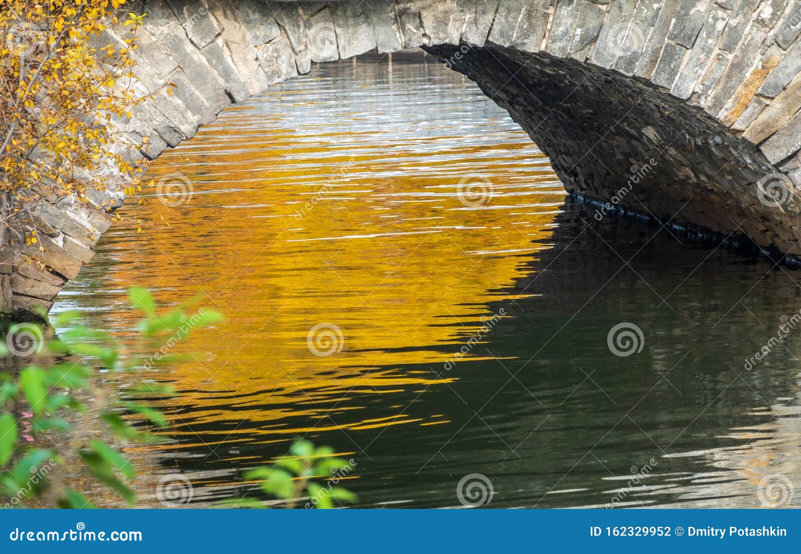 Stonework of a Bridge Pylon with Reflection in the Water Stock Photo ...