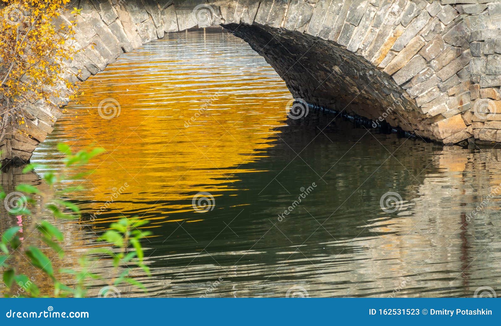 Stonework of a Bridge Pylon with Reflection in the Water Stock Image ...