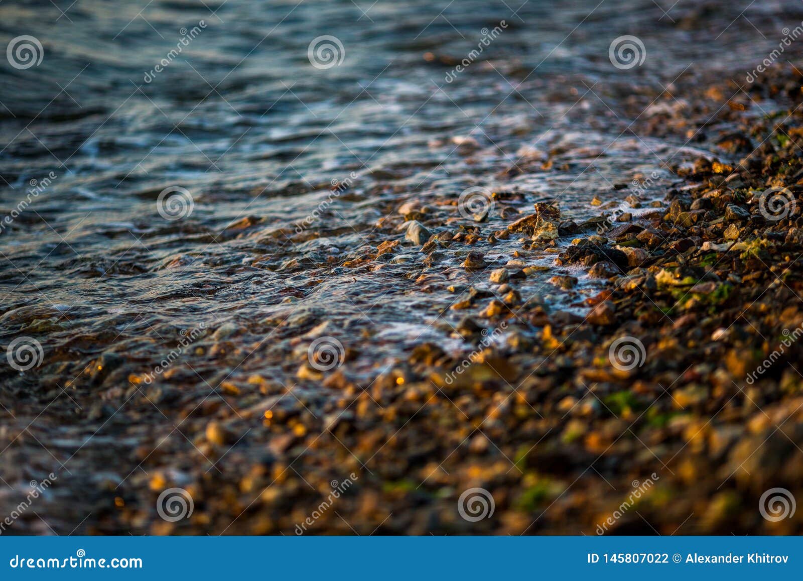 Waves Roll on Small Stones during Sunset Stock Photo - Image of golden ...