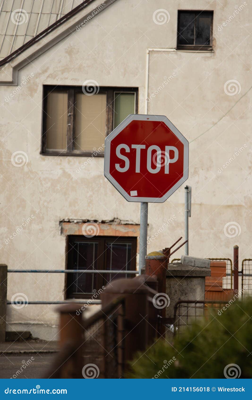 Stop Sign in Front of a Building Stock Photo - Image of communication ...