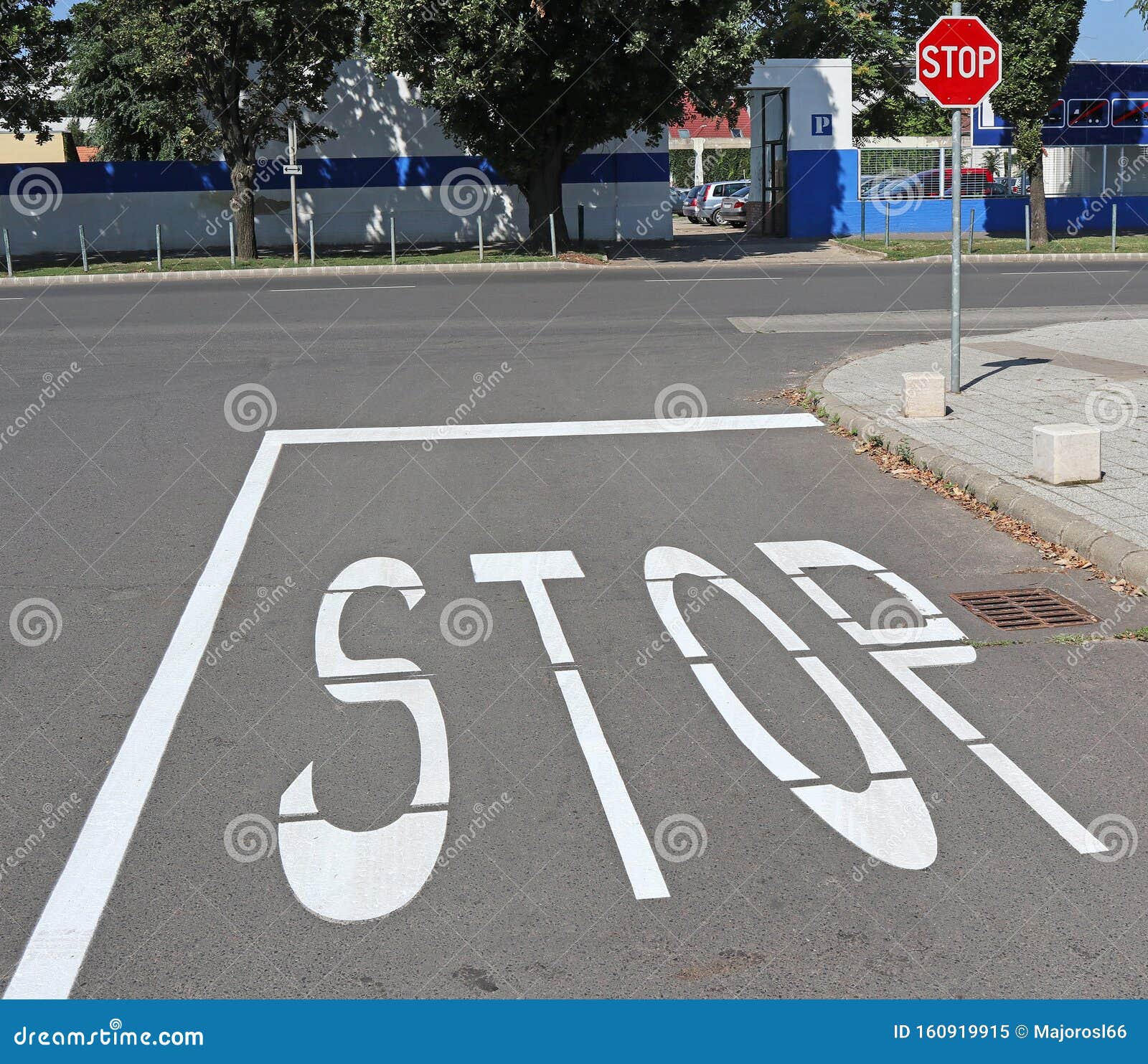 Stop Sign and Pole in the Road Crossing Stock Image - Image of lane ...