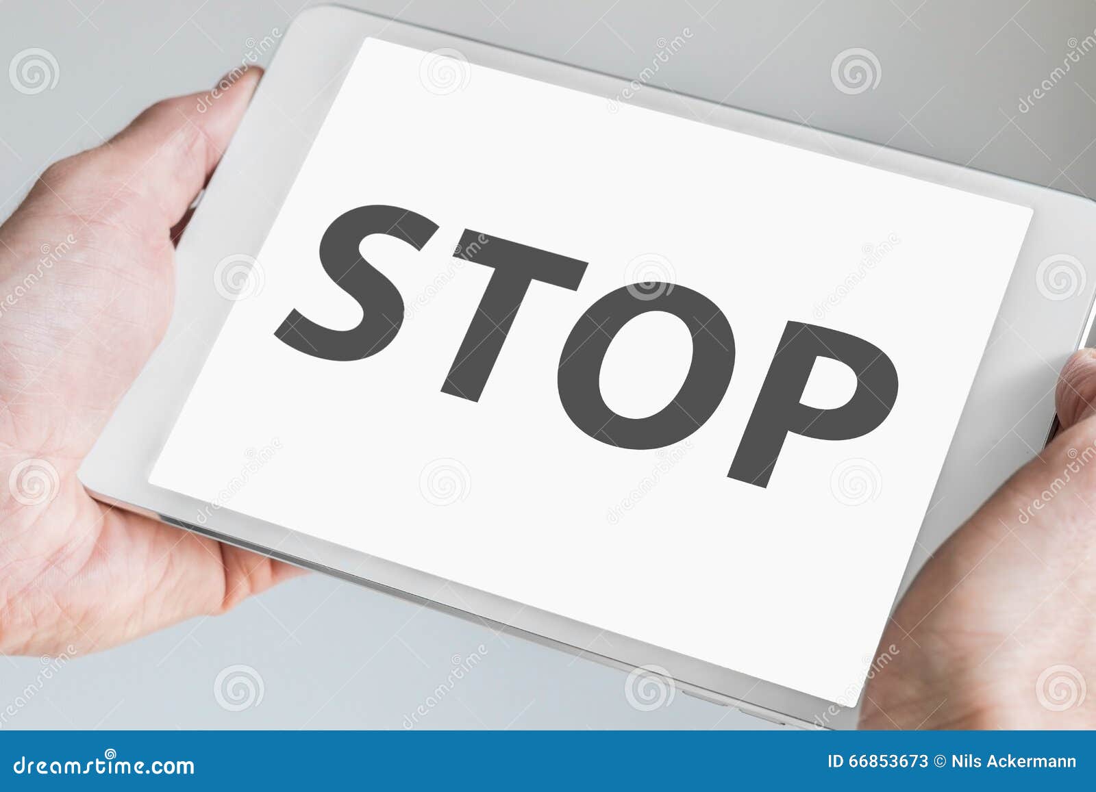 Stop Text Displayed on Touch Screen of Modern Tablet. Hands Holding ...