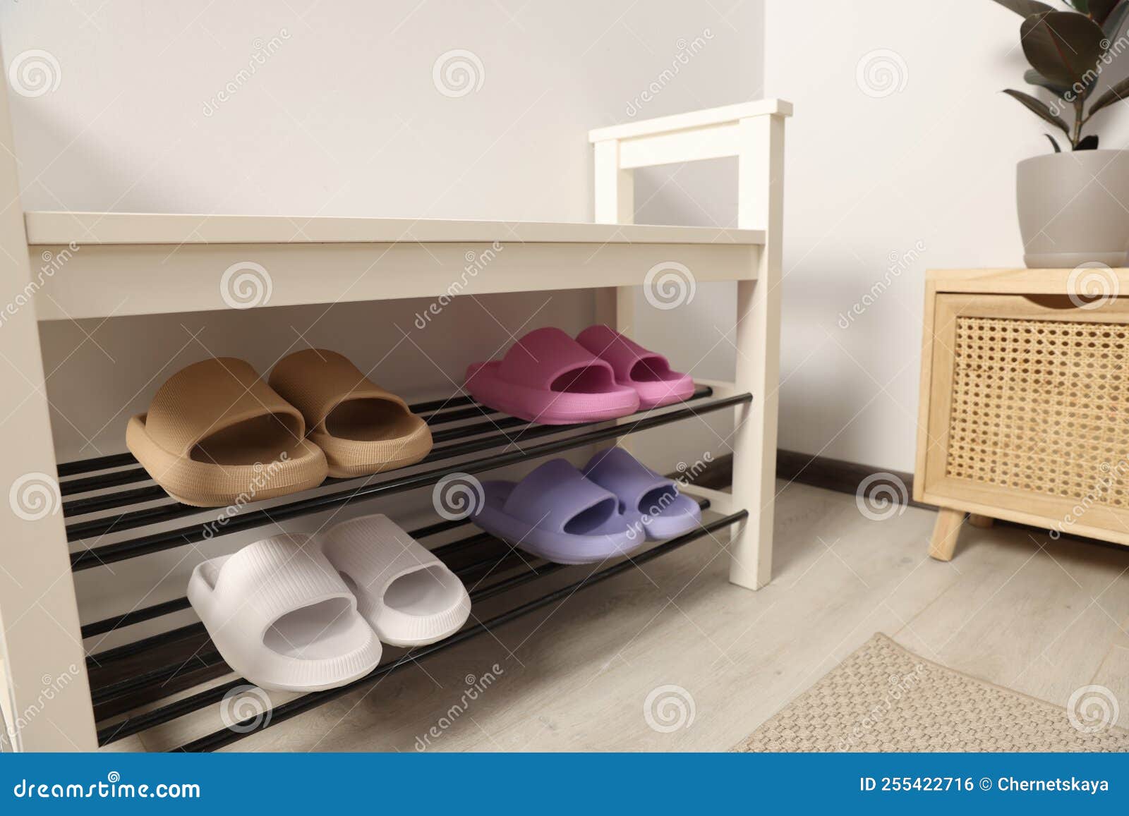 Storage Bench with Pairs of Rubber Slippers in Room Stock Photo - Image ...