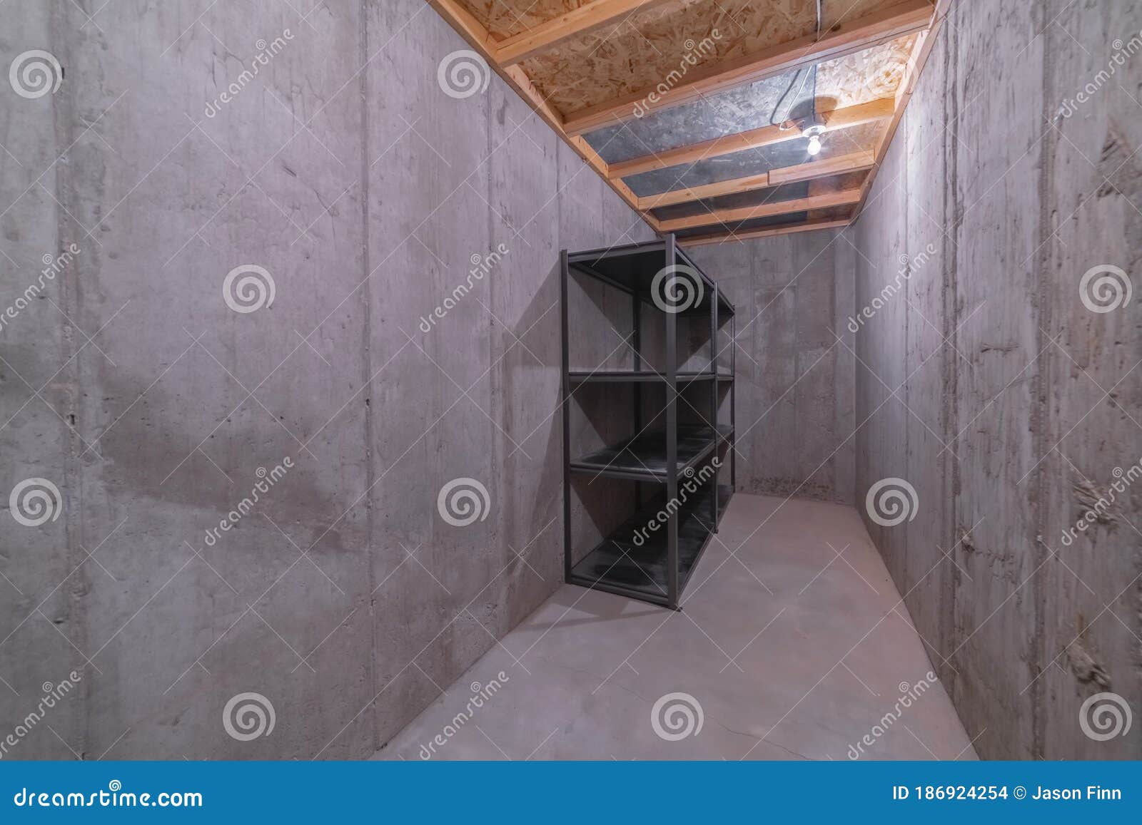 Storage Shelves in a Bare Concrete Room Stock Photo - Image of ceiling ...