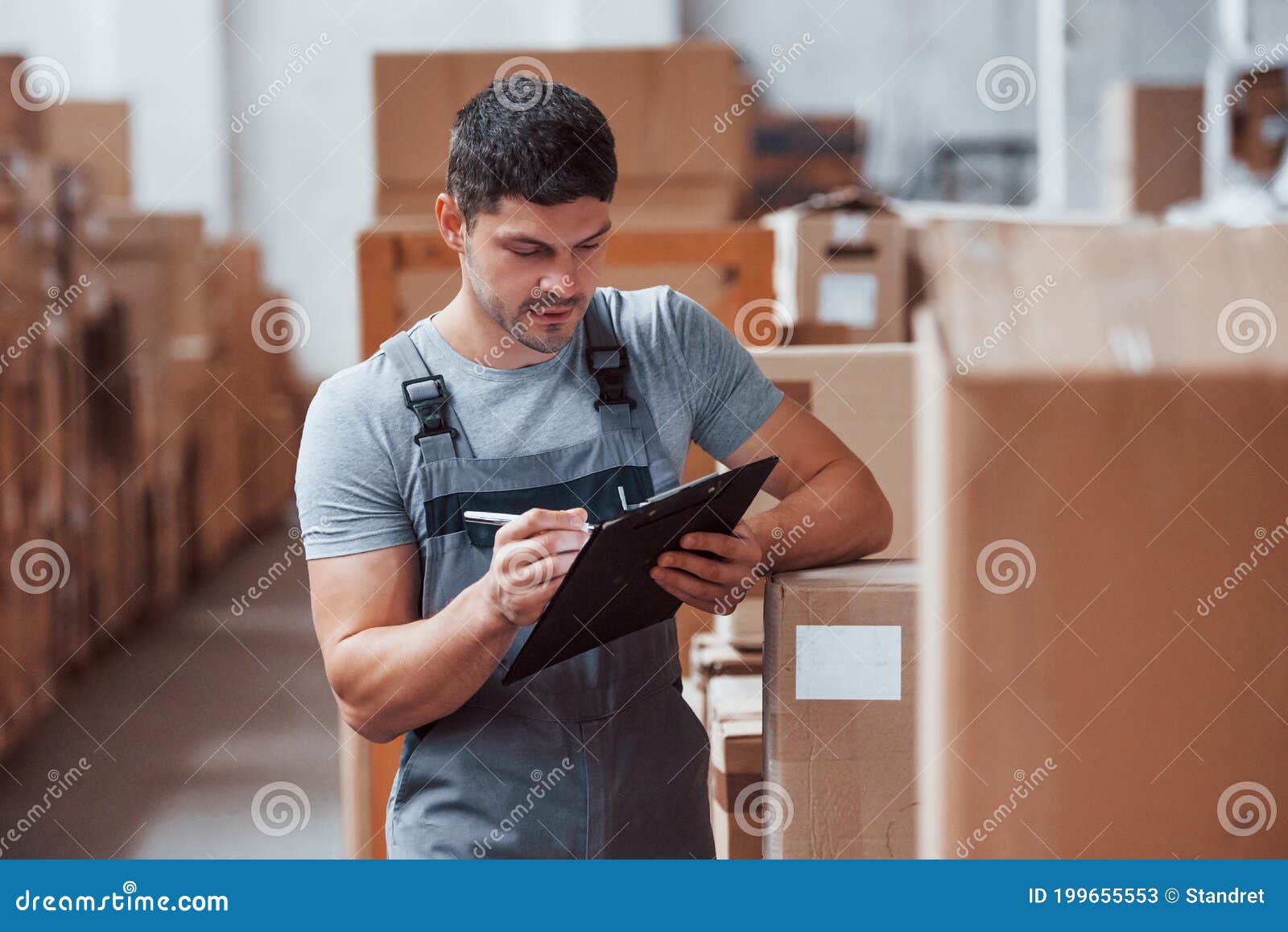 Storage Worker in Uniform and Notepad in Hands Checks Production Stock ...