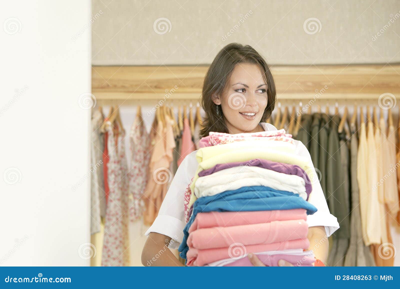Store Attendant Holding Pile of Clothes Stock Image - Image of indoors ...