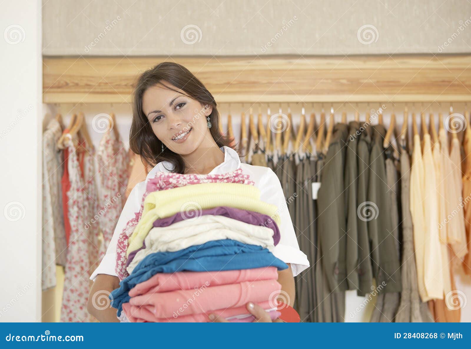 Store Attendant Holding Pile of Clothes Stock Photo - Image of hanging ...