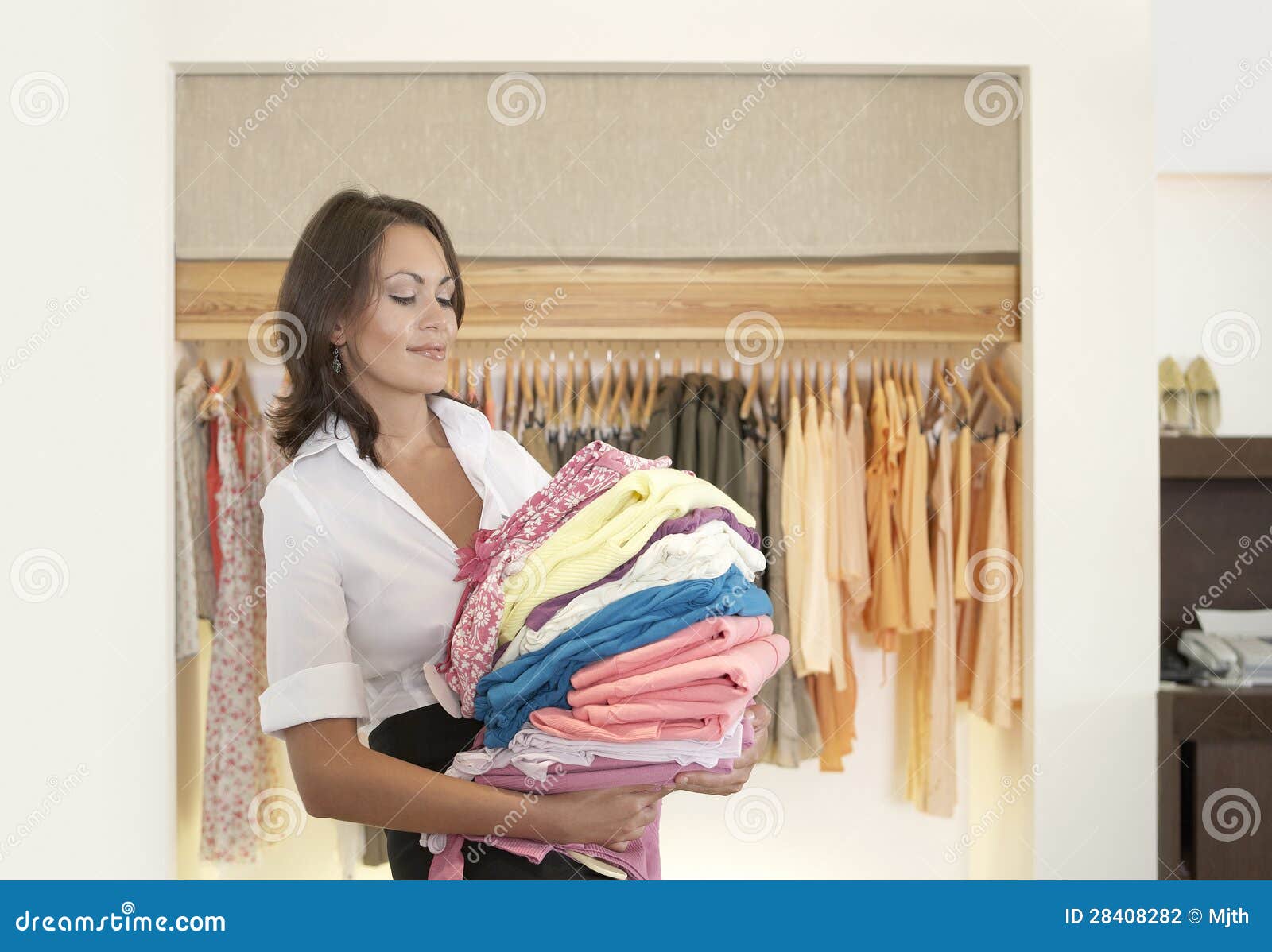 Store Attendant Holding Pile of Clothes Stock Photo - Image of growth ...