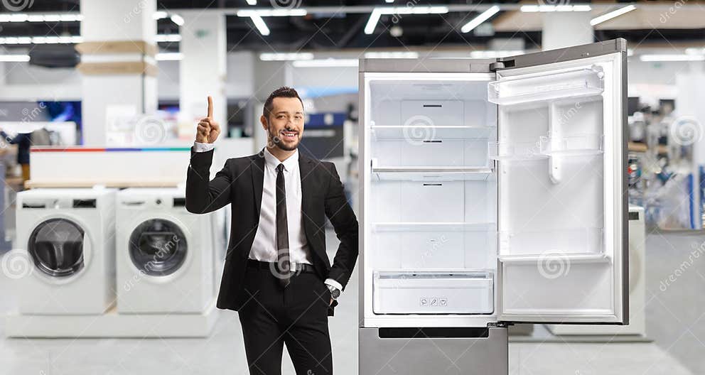 Store Manager Leaning on a Fridge Stock Photo - Image of freezer ...
