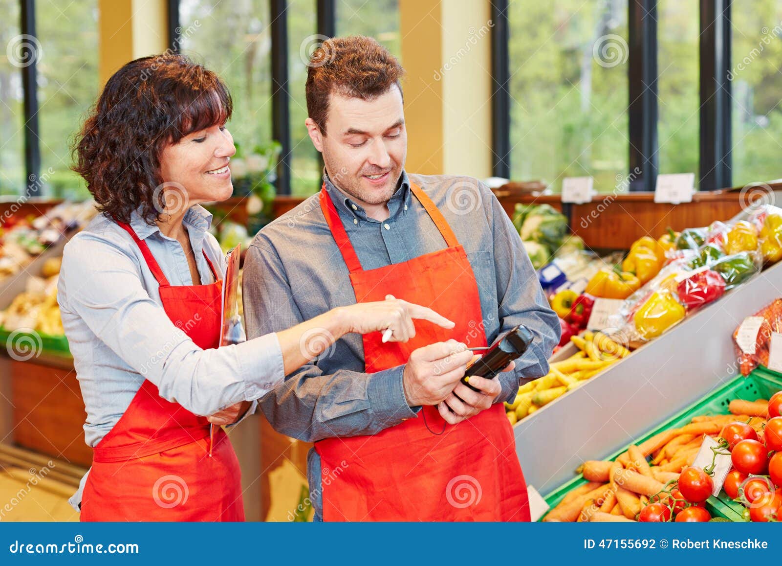 Store Manager Showing Staff How To Use Data Terminal Stock Photo ...