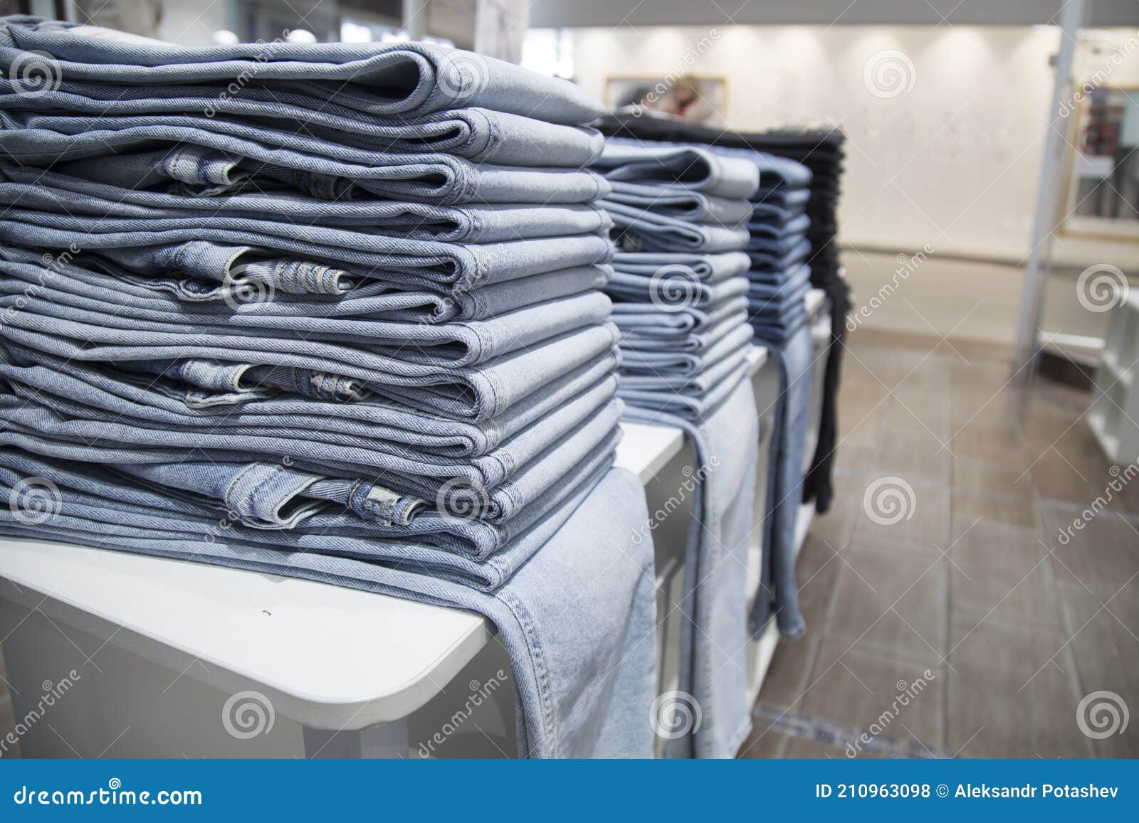 A Store that Sells Jeans. Jeans on the Counter of the Store Stock Photo ...