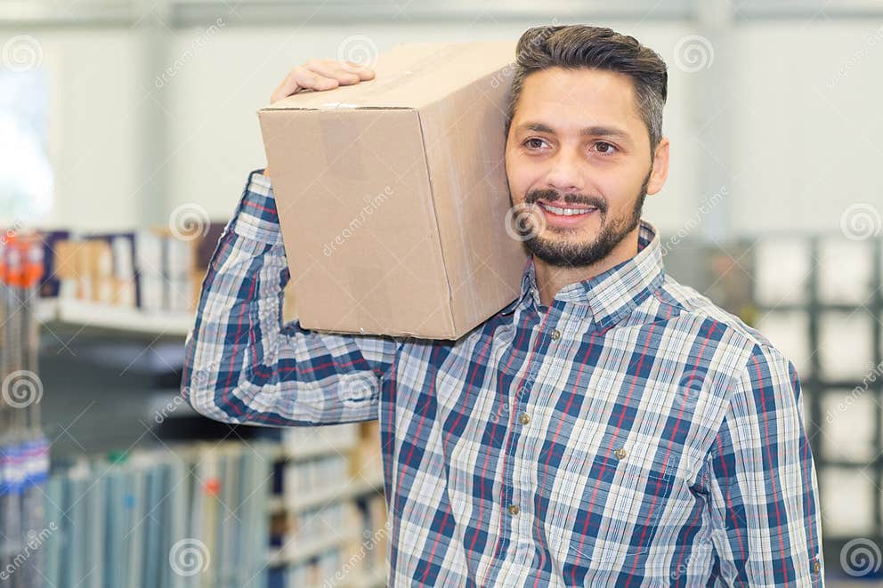 Store worker carrying box stock photo. Image of sell - 316706392