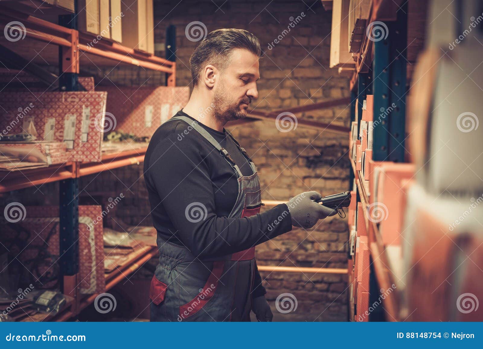Storekeeper with Handheld Barcode Scanner Working in a Warehouse Stock ...