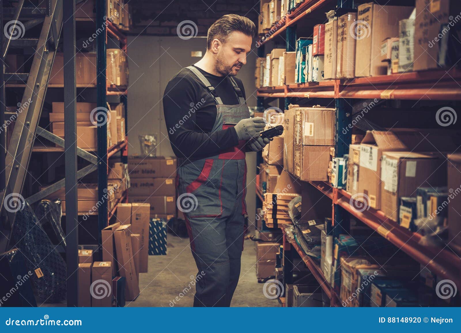 Storekeeper With Handheld Barcode Scanner Working In A Warehouse ...