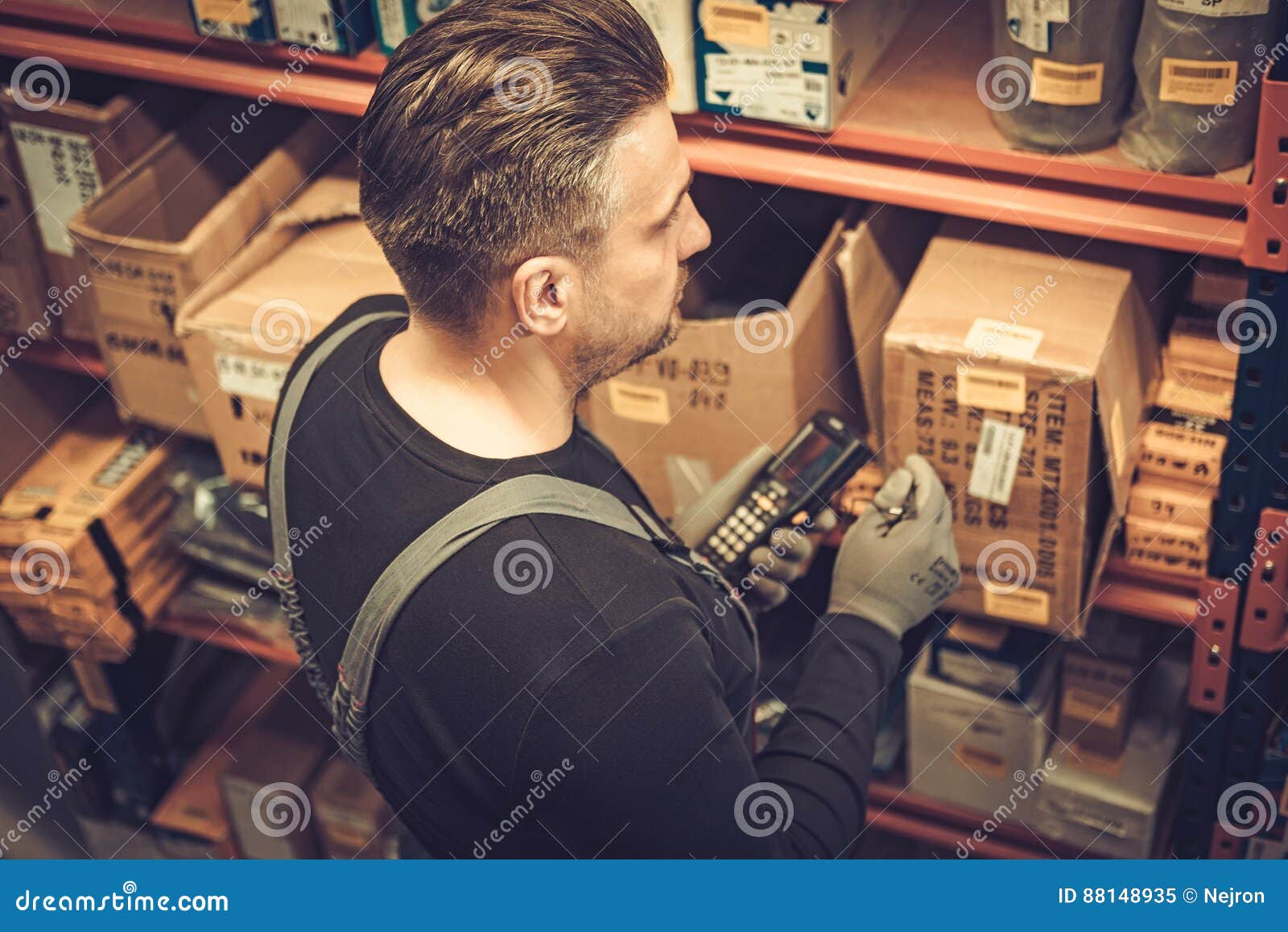 Storekeeper with Handheld Barcode Scanner Working in a Warehouse Stock ...