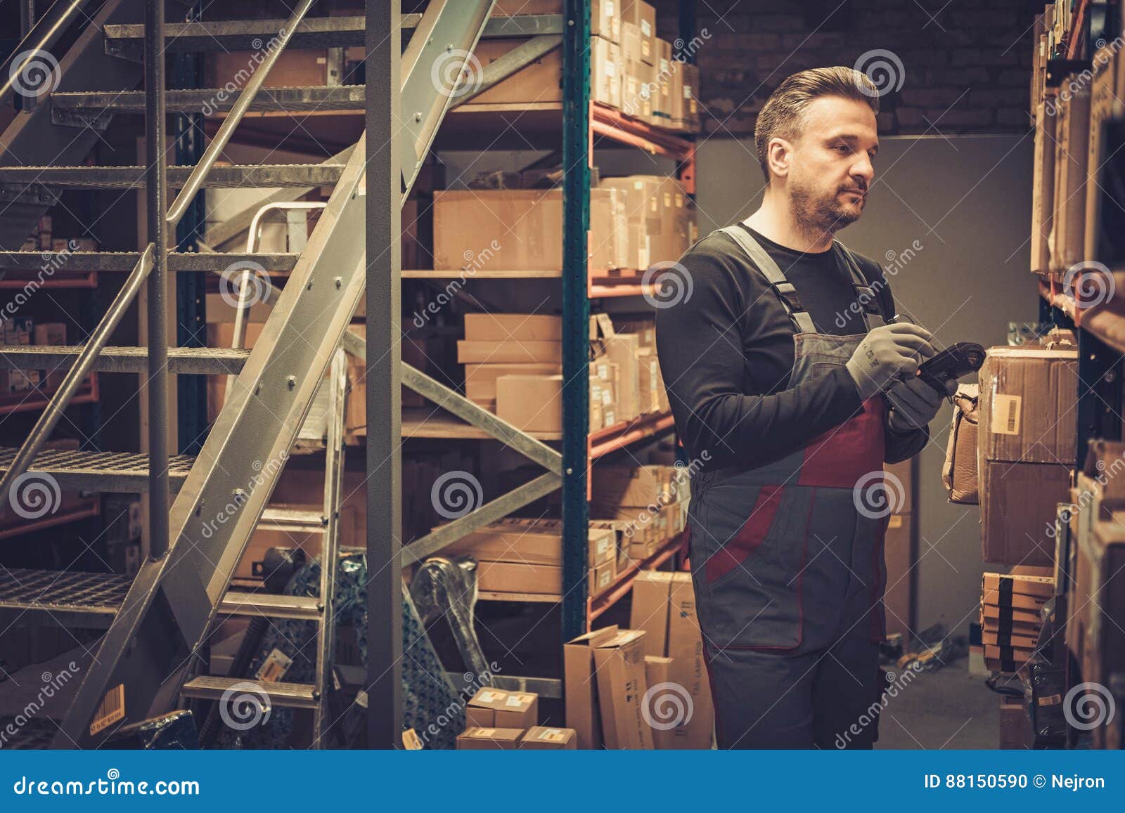 Storekeeper with Handheld Barcode Scanner Working in a Warehouse Stock ...