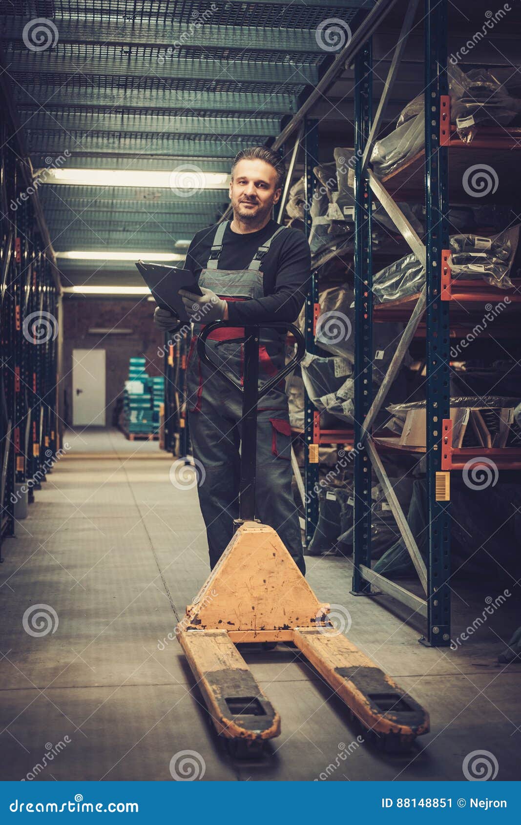 Storekeeper Working with Pallet Truck in a Warehouse Stock Image ...