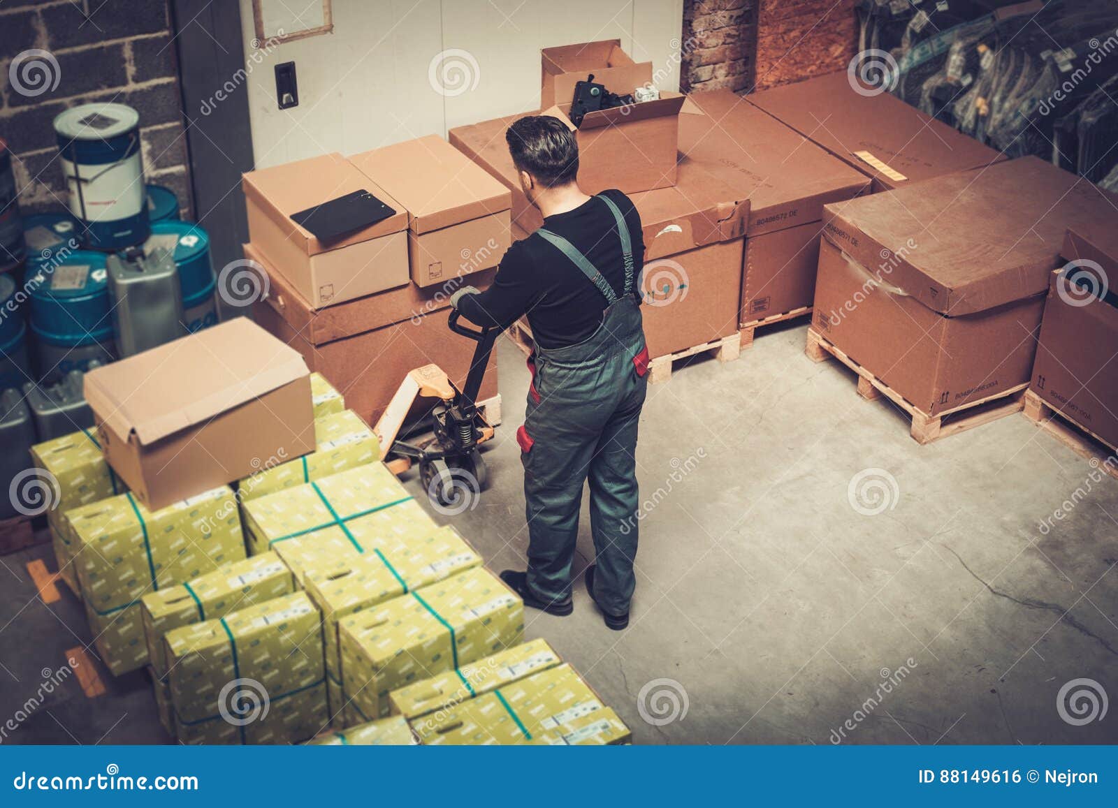 Storekeeper Working with Pallet Truck in a Warehouse Stock Photo ...