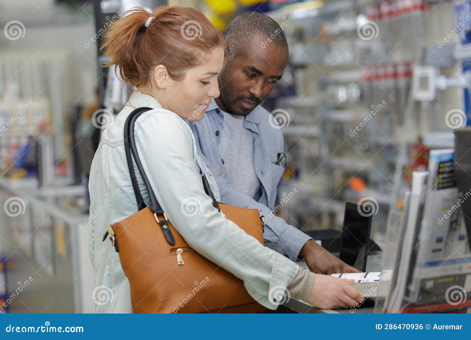 Storeman in Hardware Store Helps Female Customer Stock Photo - Image of ...