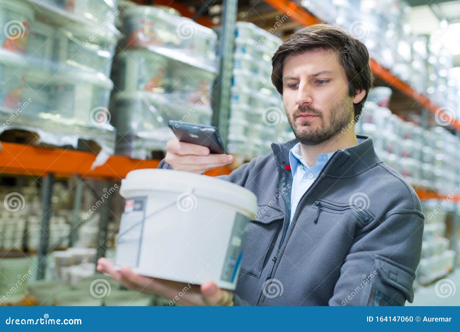 Storeman Scanning Product in Plastic Container with Smartphone Stock ...