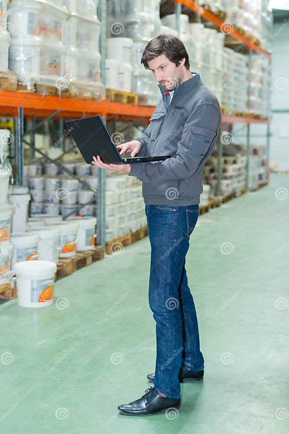 Storeman Using Laptop in Warehouse Stock Image - Image of working ...