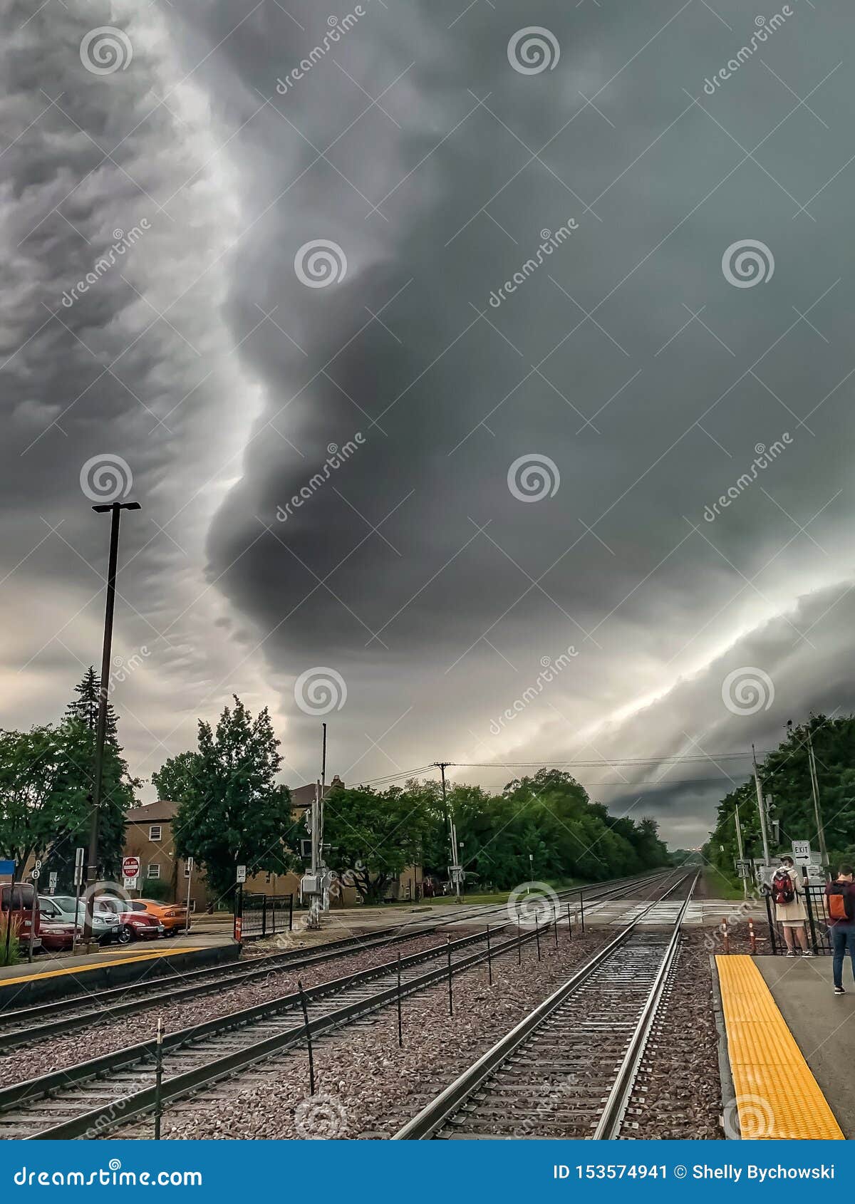 Storm Clouds Form Patterns Over Metra Tracks and Train Station Platform ...
