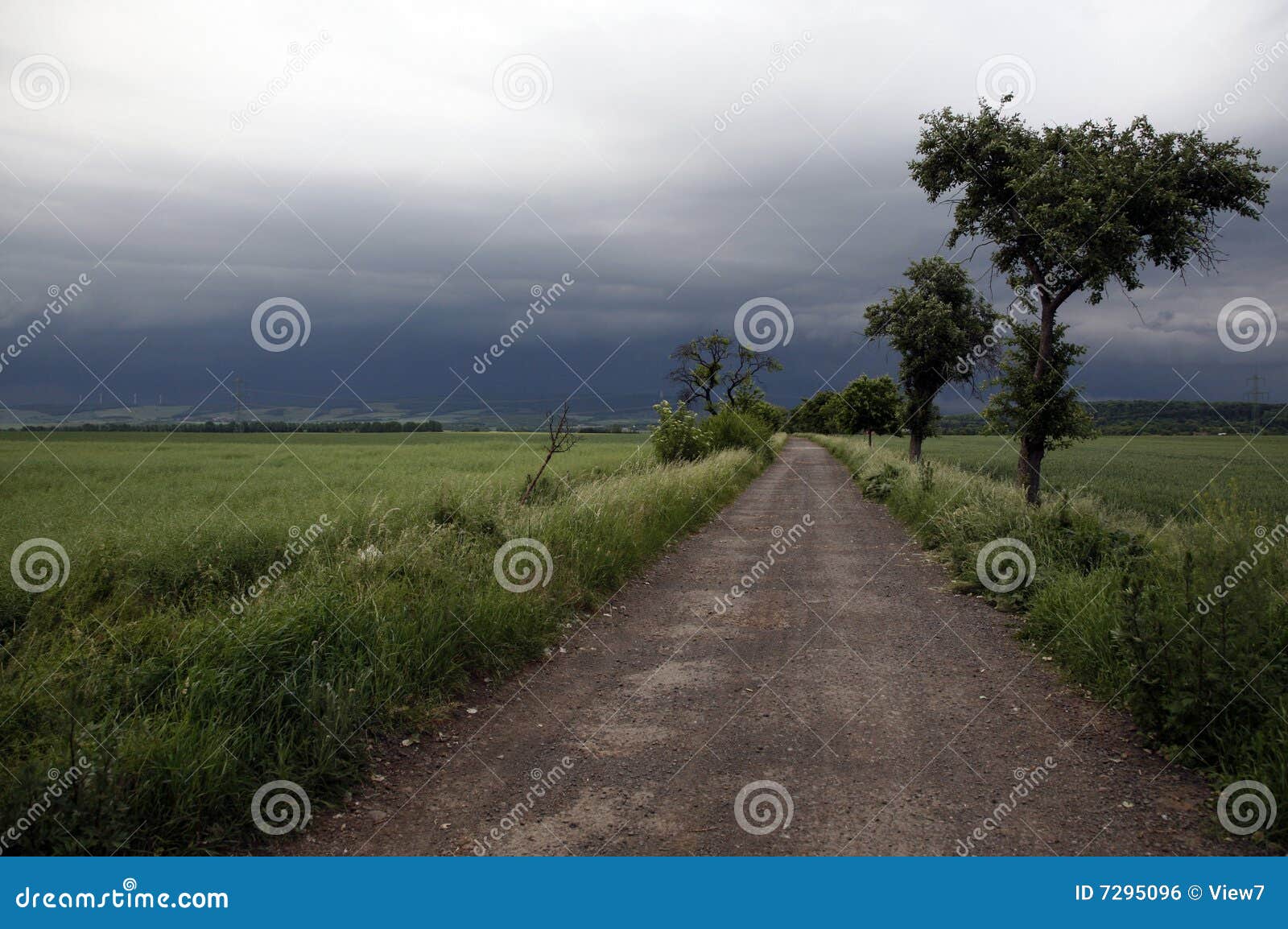 Storm Clouds Over Country Road Stock Photo - Image of moody, inclement ...