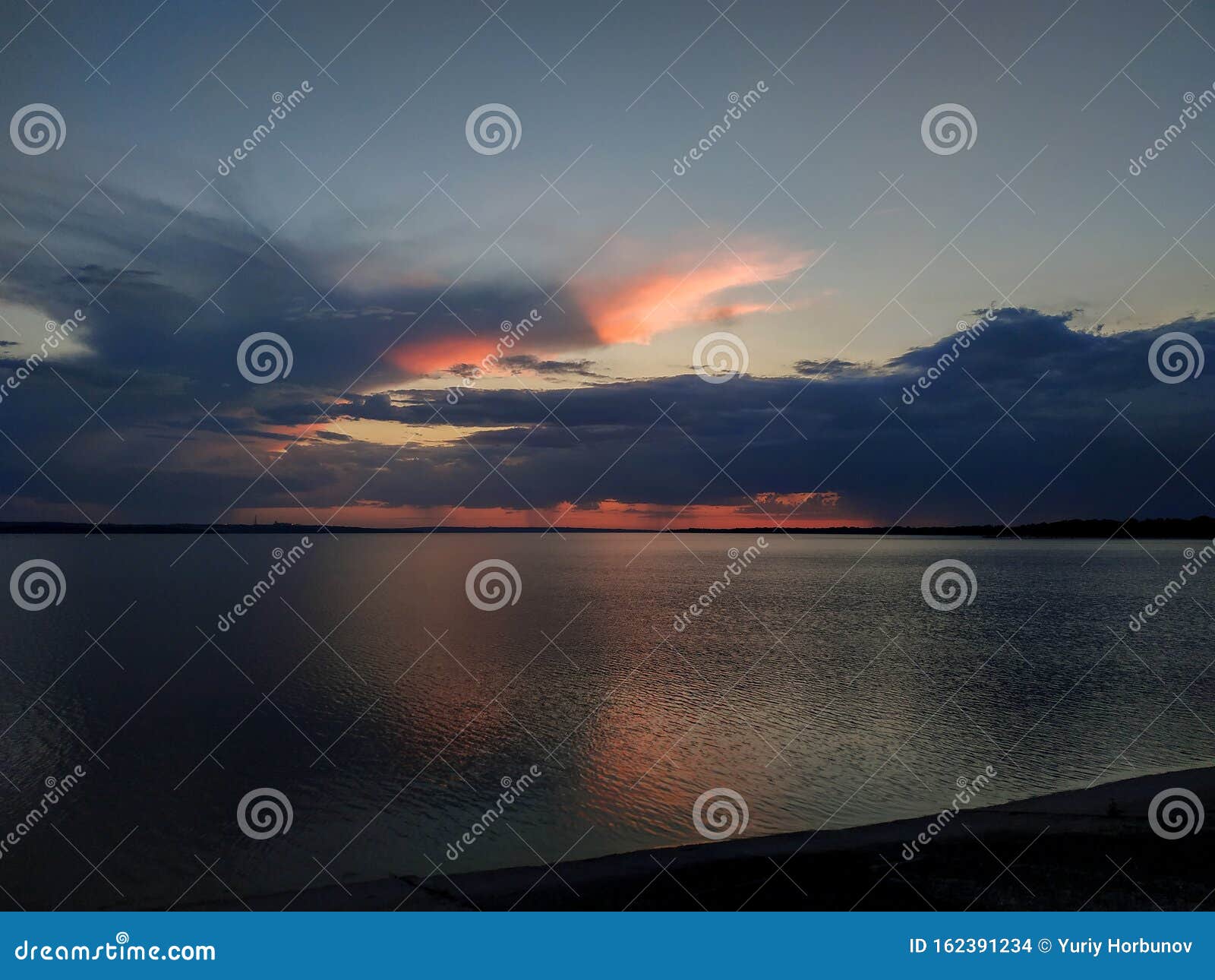 Storm Clouds with Rain Over the Lake at Sunset Stock Photo - Image of ...