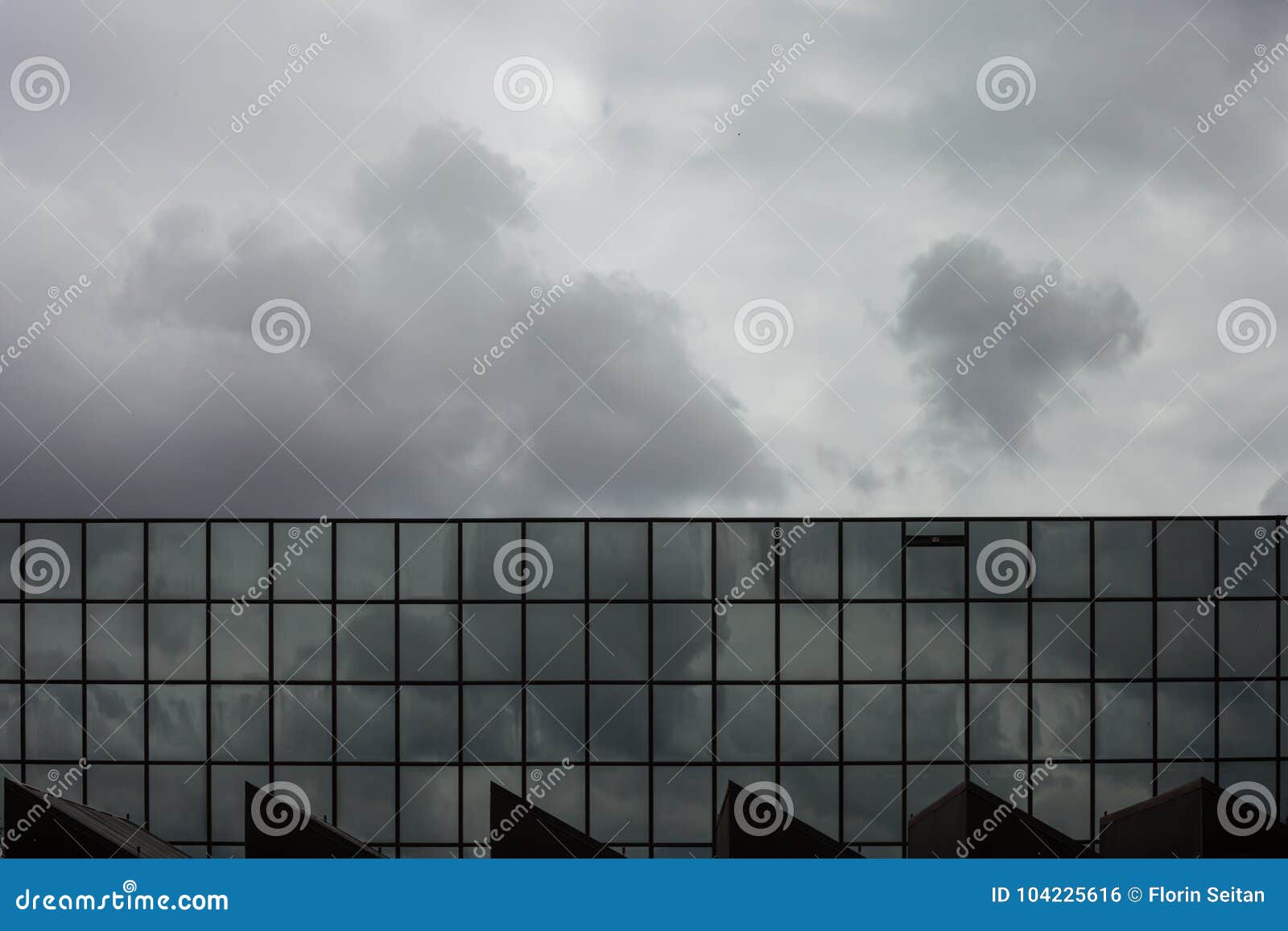 Storm Clouds Reflect in Windows of Office Building/ Mirror Windows with ...