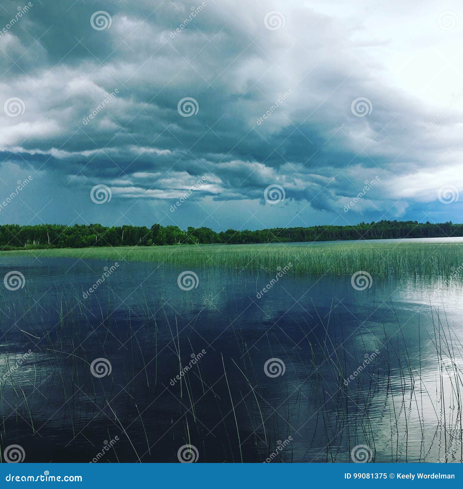 Storm in distance stock image. Image of green, lake, reflection - 99081375