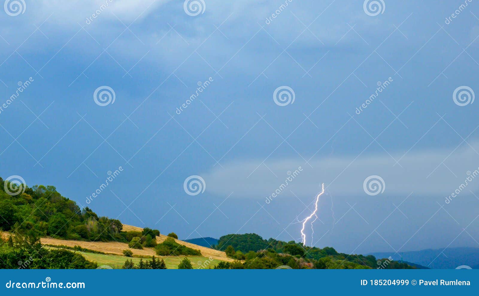 Storm with Lightning Over the Hilly Landscape. Lightning Strikes ...
